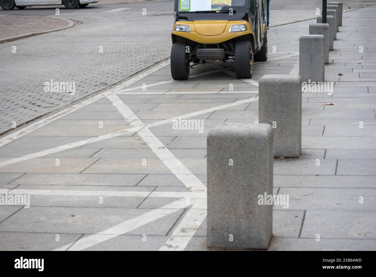 an electric car driving on a paved road Stock Photo - Alamy