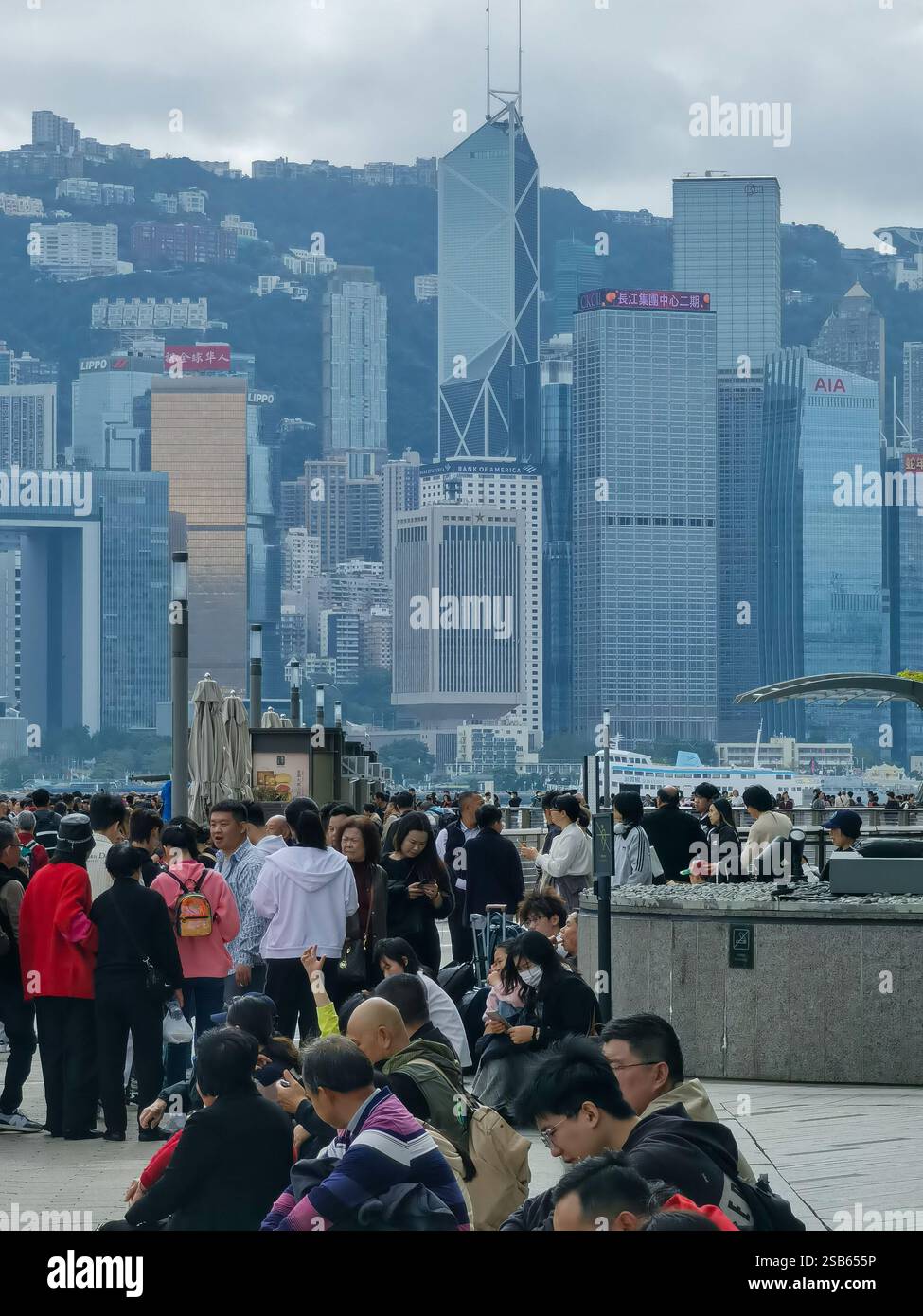 Hong Kong, China - February 01, 2025 : A bustling crowd enjoys the Tsim ... Hong Kong, China - February 01, 2025 : A bustling crowd enjoys the Tsim ...