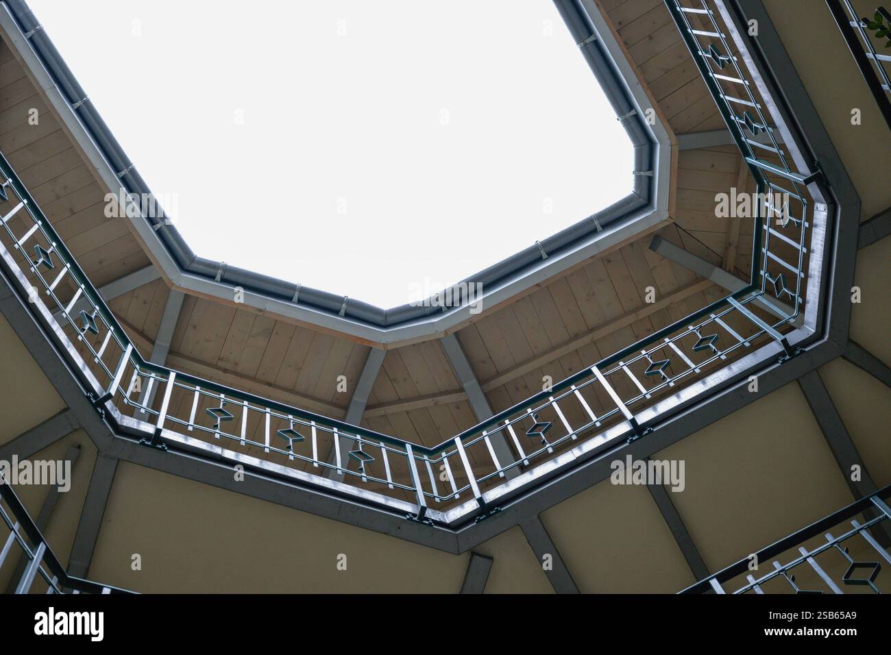 a view up to a blue sky through a glass skylight with a metal frame ...
