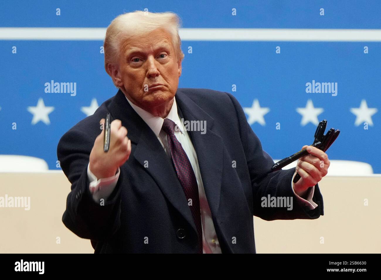 FILE - President Donald Trump throws pens used to sign executive orders ...