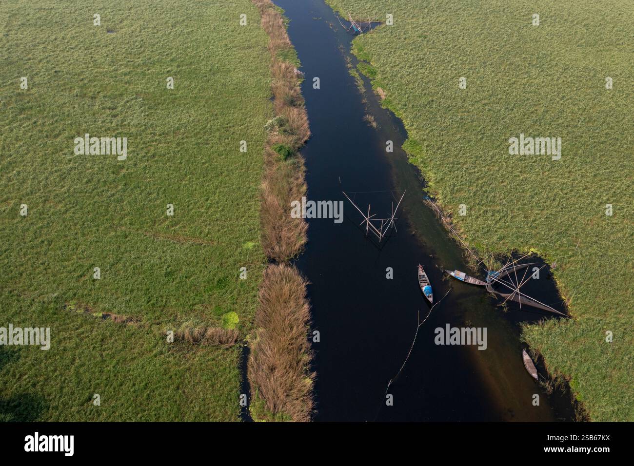 Aerial view of a vast marsh dotted with traditional fishing traps in ...