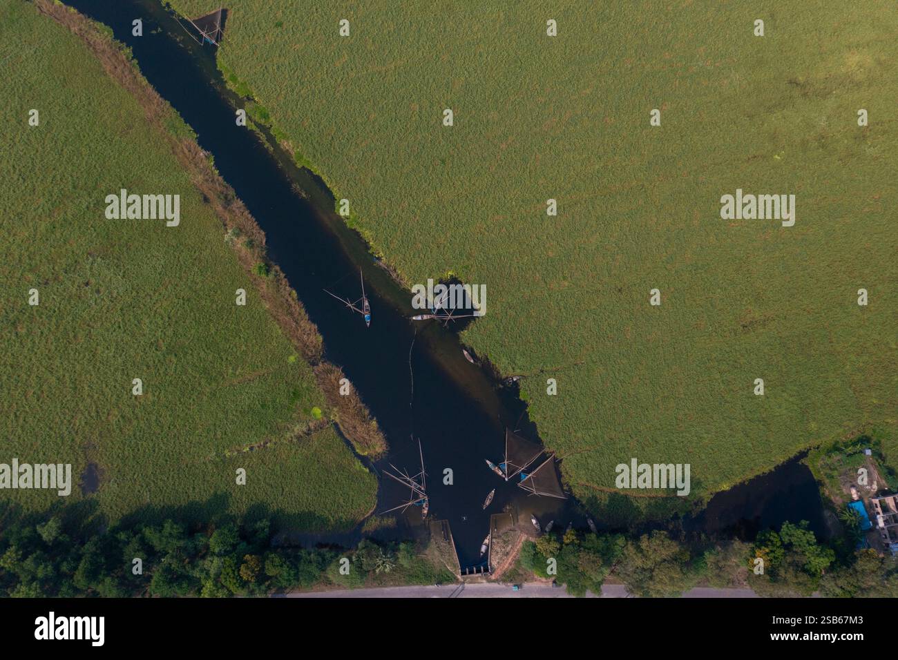 Aerial view of a vast marsh dotted with traditional fishing traps in ...