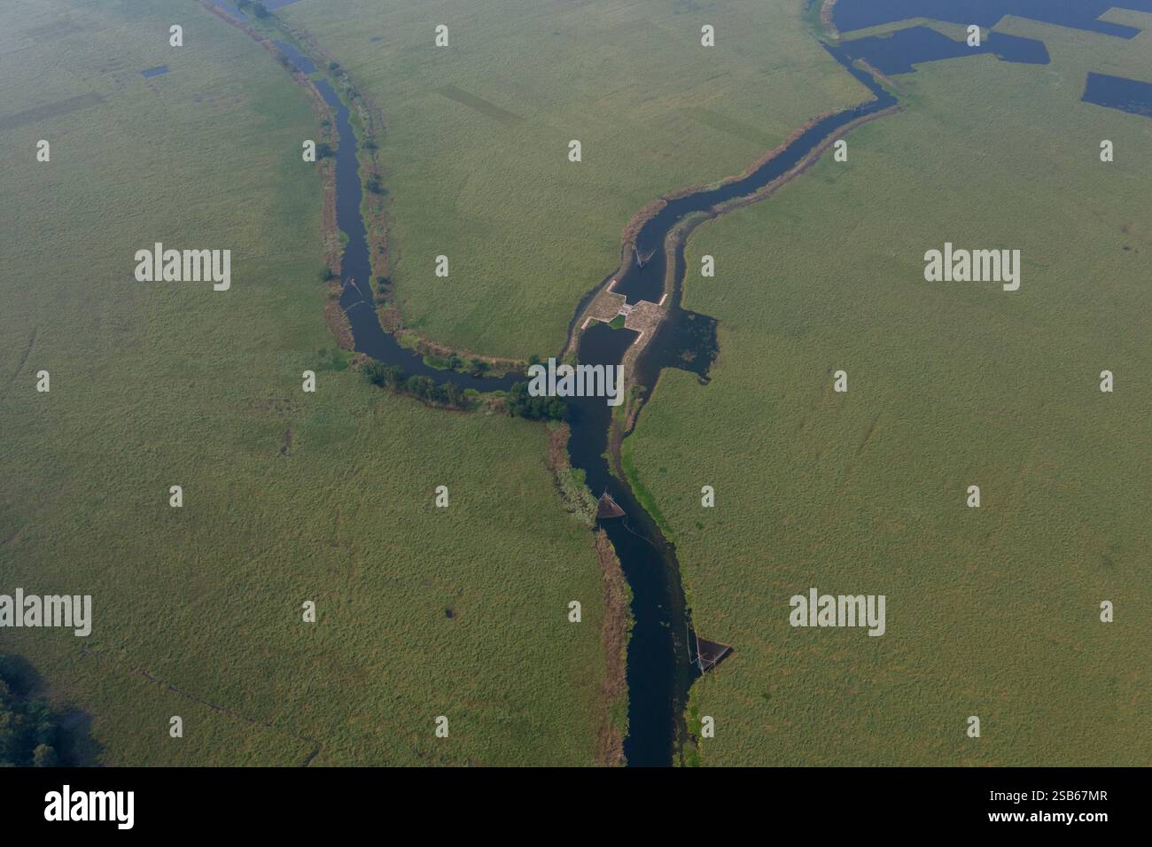 Aerial view of a vast marsh dotted with traditional fishing traps in ...