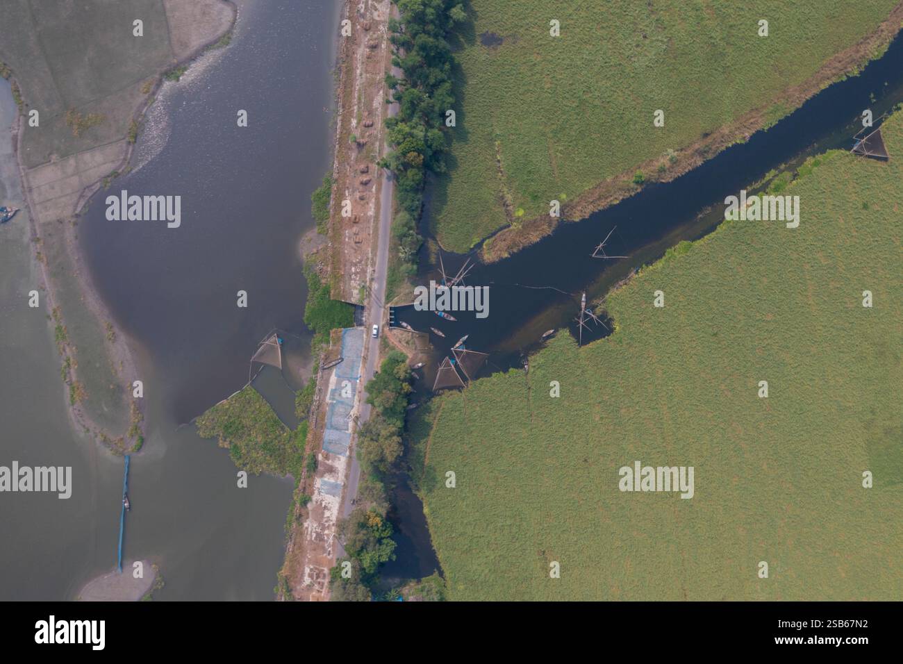 Aerial view of a vast marsh dotted with traditional fishing traps in ...