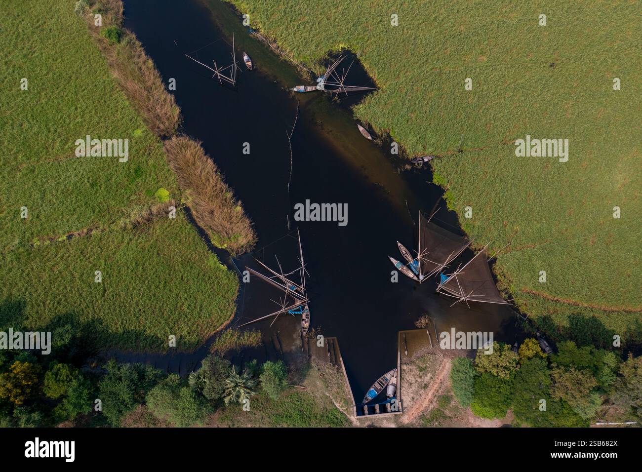 Aerial view of a vast marsh dotted with traditional fishing traps in ...