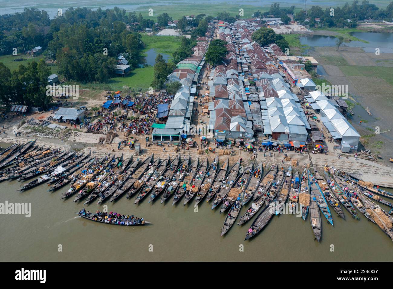 Aerial view of the bustling riverside bazar, Nakalia, with a fleet of boats anchored along the ...