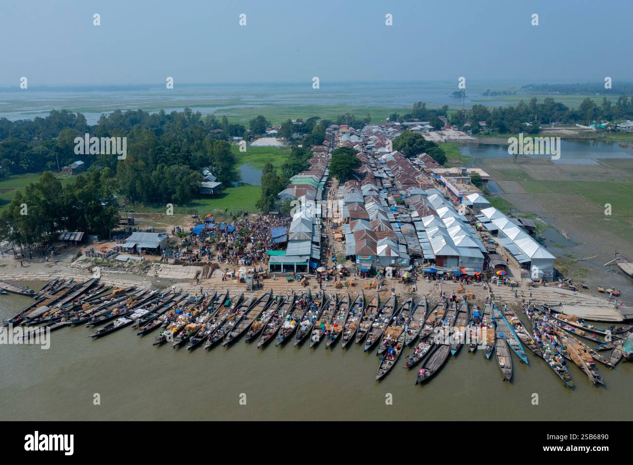 Aerial view of the bustling riverside bazar, Nakalia, with a fleet of boats anchored along the ...