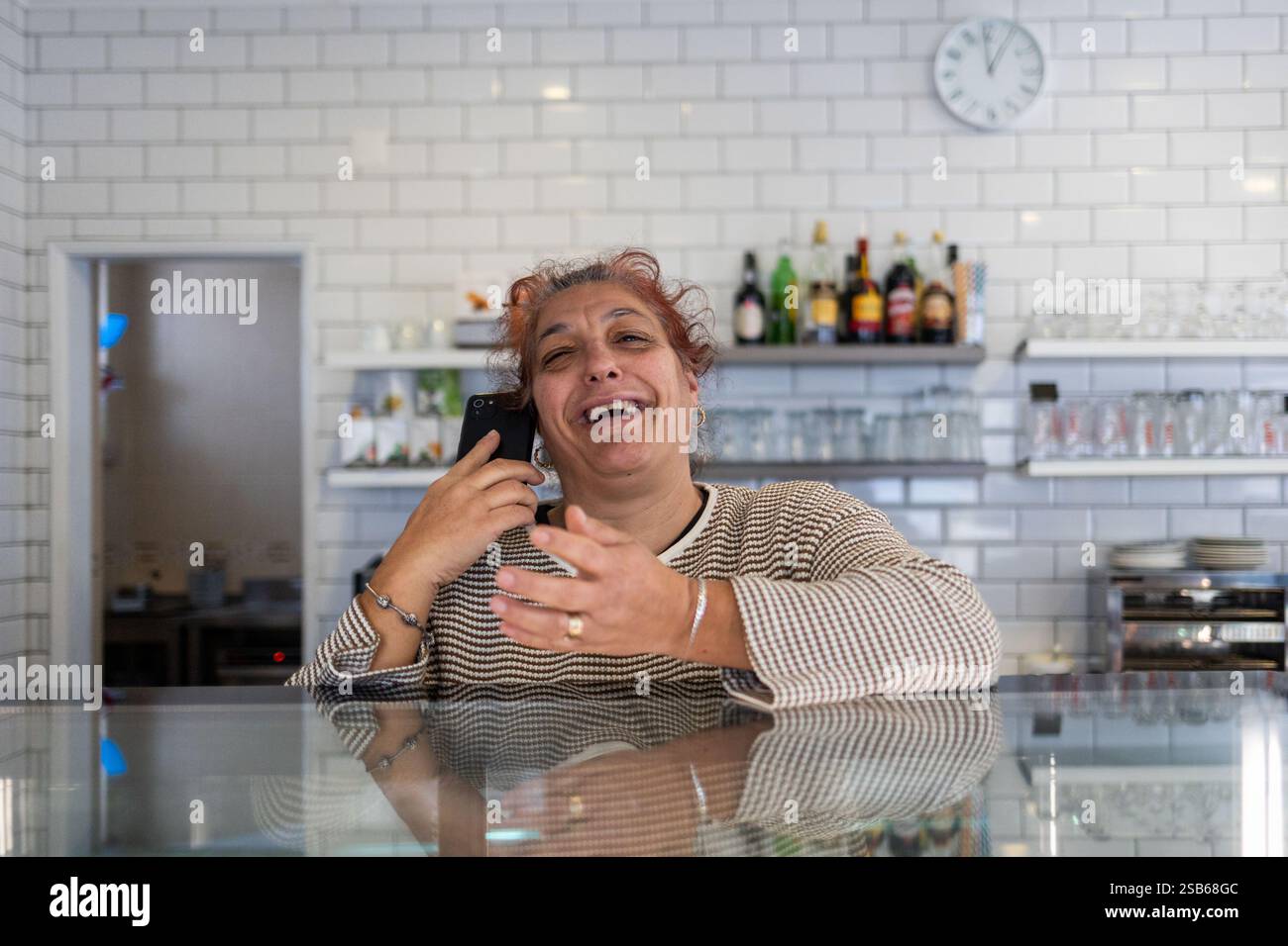 Carla Natalya, the owner of a small café, poses for a photo inside her ...