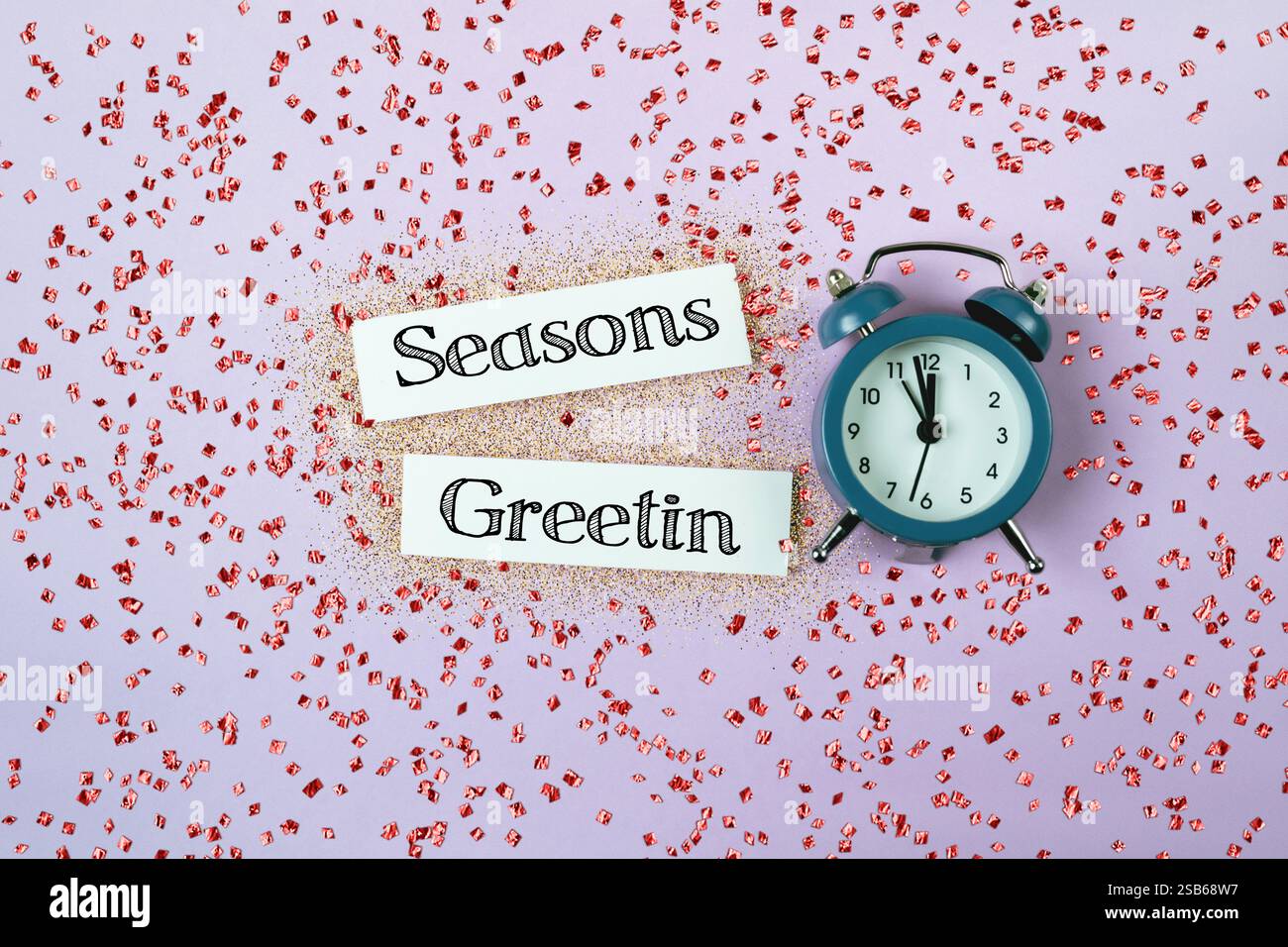 Blue alarm clock sits on a pink background with the words Seasons ...