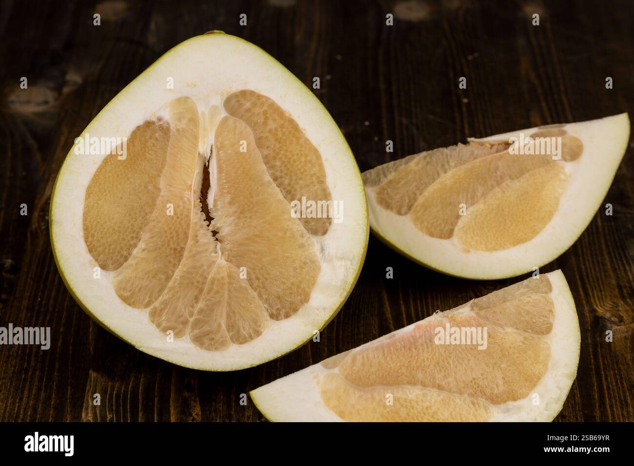 ripe pomelo with lots of pulp cut into pieces, huge juicy citrus close ...