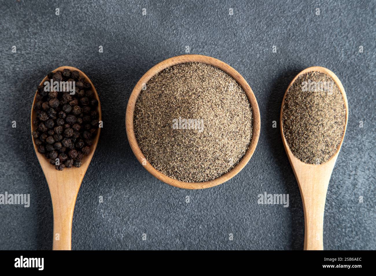 Ground black pepper with grains of black pepper on gray background ...