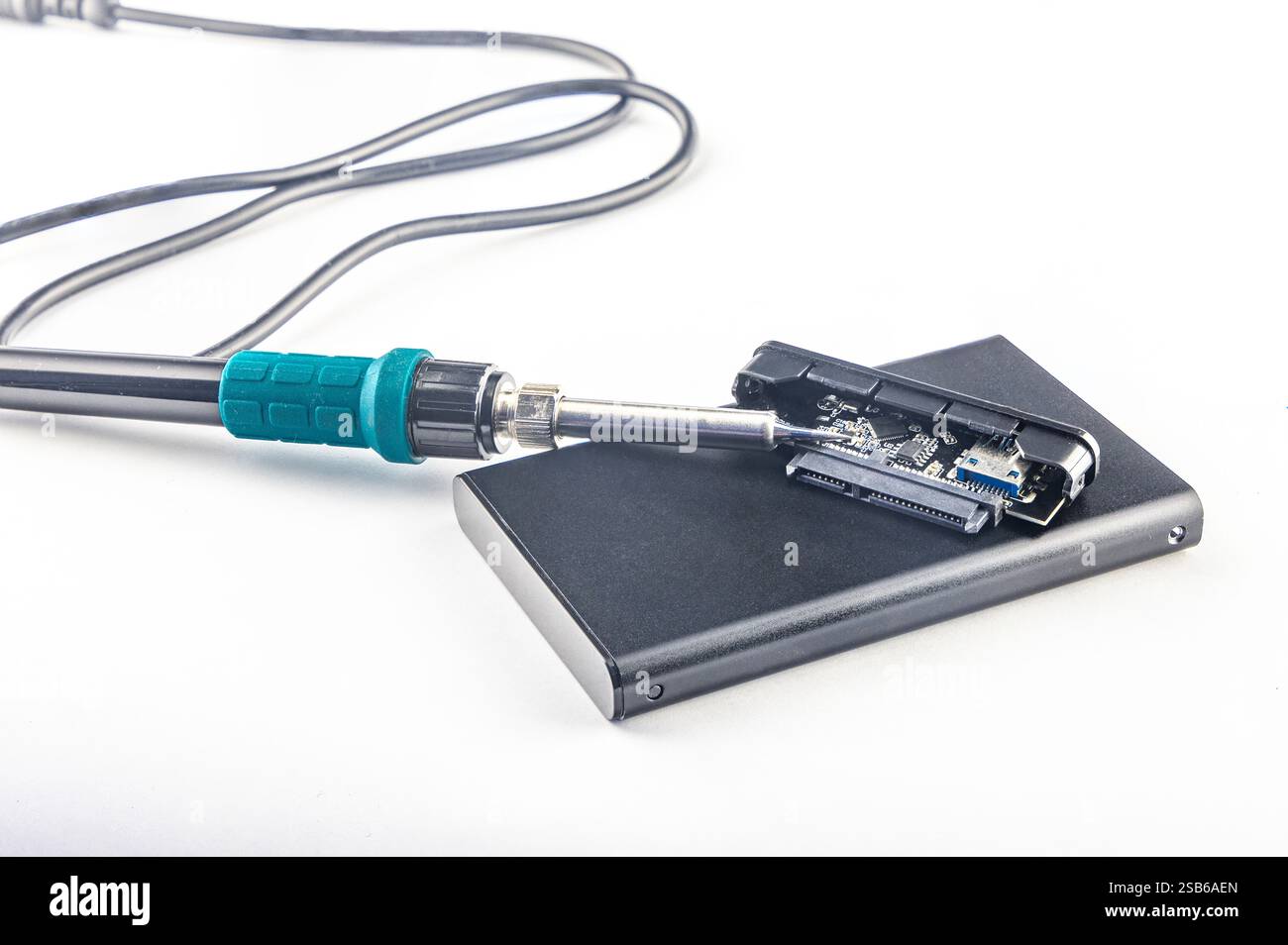 Damaged external drive, transformer soldering iron on white background ...