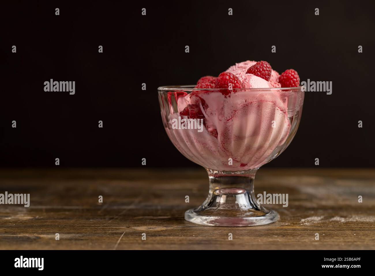 raspberry ice cream in a glass bowl close up, delicious sweet cold ...