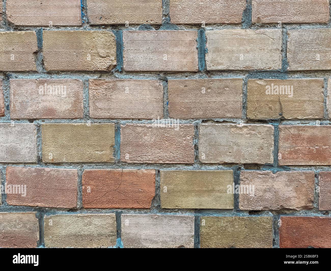 Brick wall with a brown and tan color. The wall is made of bricks and ...