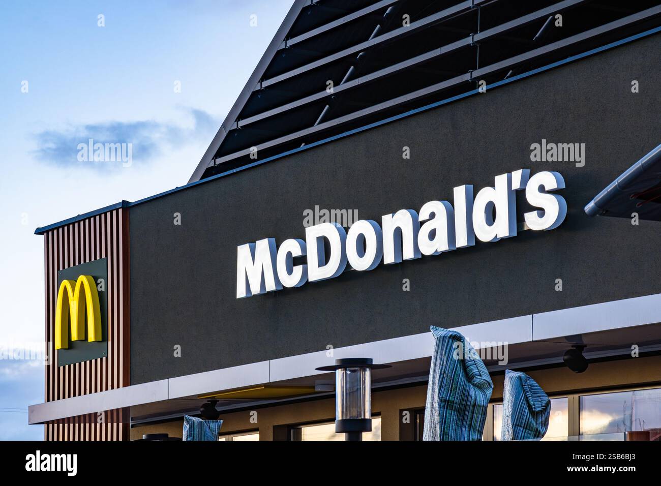 The vibrant signage of a popular fast food location illuminates the ...
