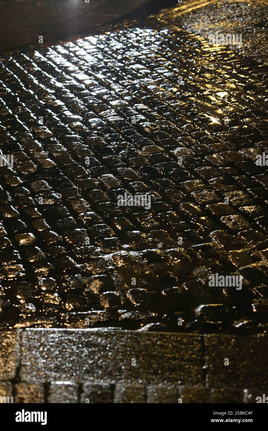 Dublin, Ireland - 28th January 2025 - wet rain soaked cobblestones on a ...