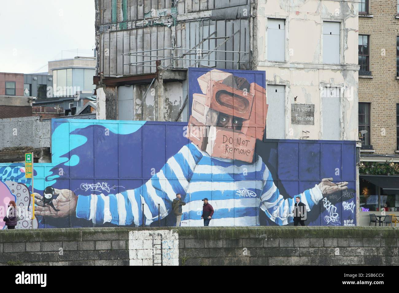 Dublin, Ireland - 28th January 2025 - a large mural of a man with bricks around his head with ...
