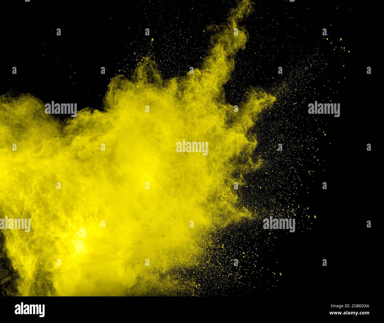 Yellow explosion of powdery dust is blowing out of a black background ...