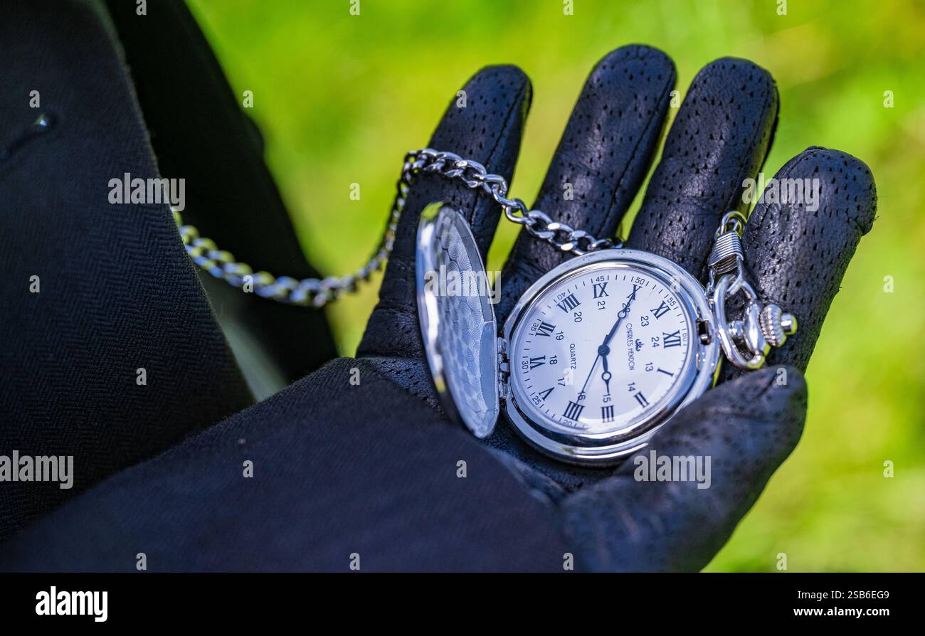 Traditional silver pocket watch held in a gloved hand Stock Photo - Alamy