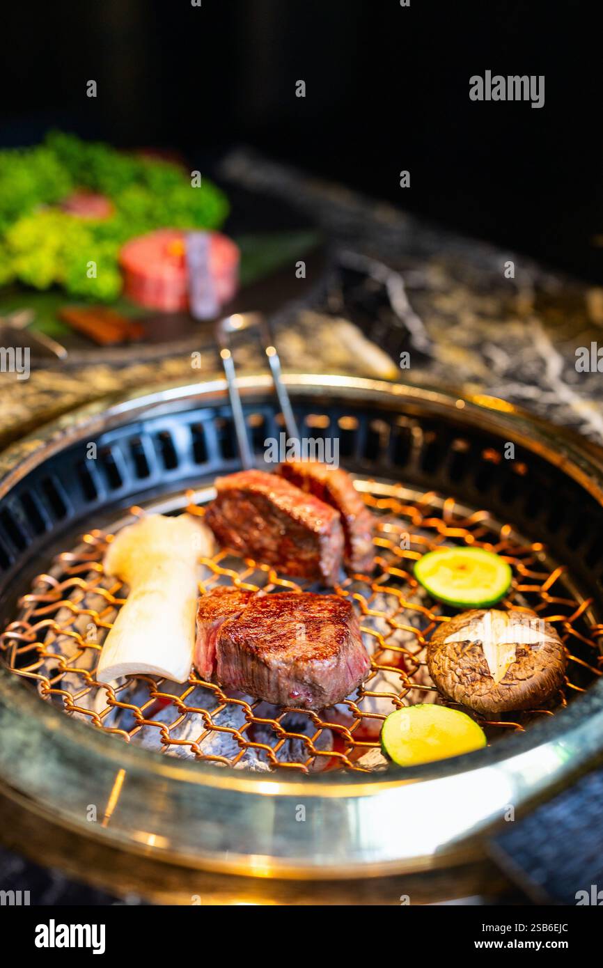 Sizzling cuts of premium beef, mushroom, and zucchini grilling over a ...