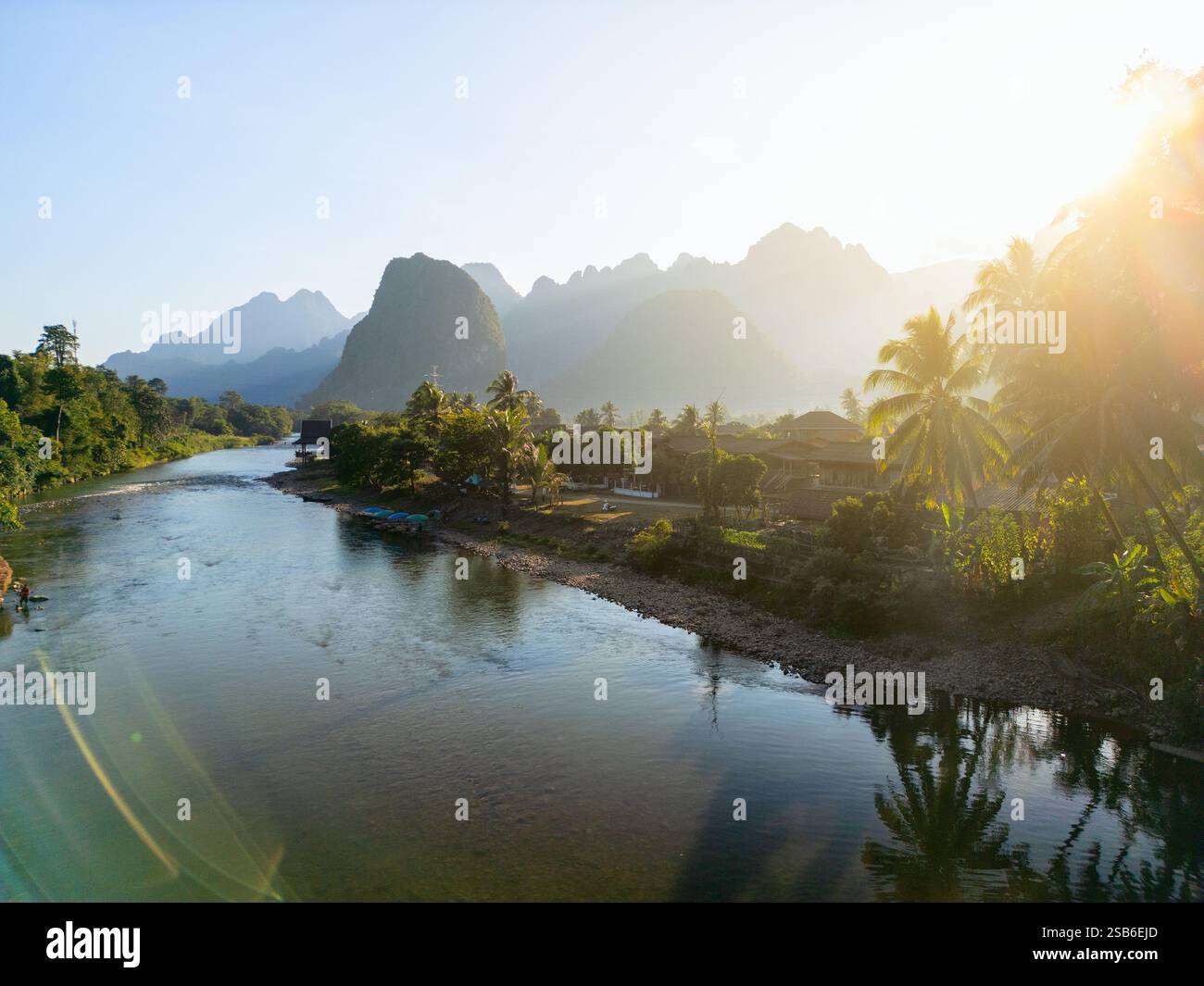 An aerial image of Vang Vieng, Laos, showcasing a serene river winding ...