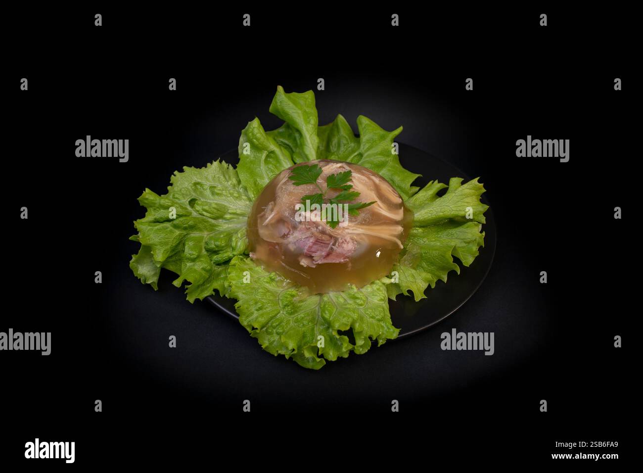 Romanian Christmas dish racituri, kholodets, or kocsonya, on lettuce ...