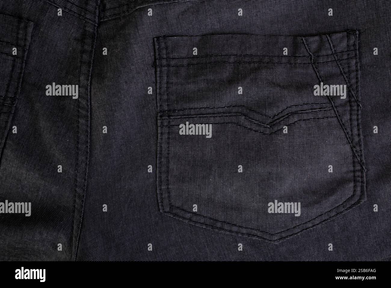 Black jeans texture with sewing pattern back pocket, abstract close up ...