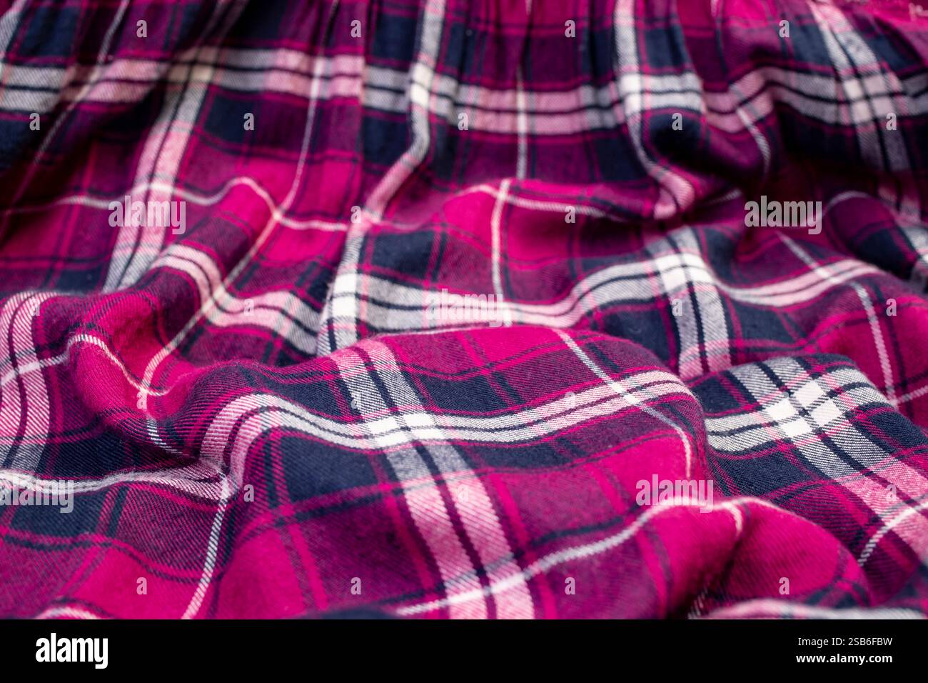 Checkered red fabric creased with podium in focus for product placement ...