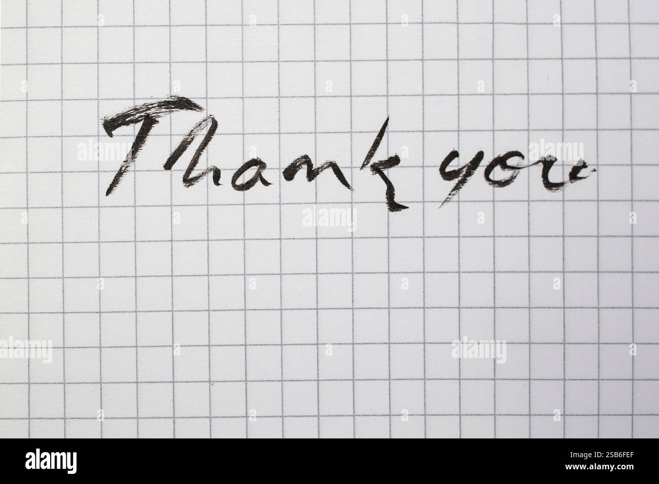 Thank you words hand written on square patterned math copy book page ...