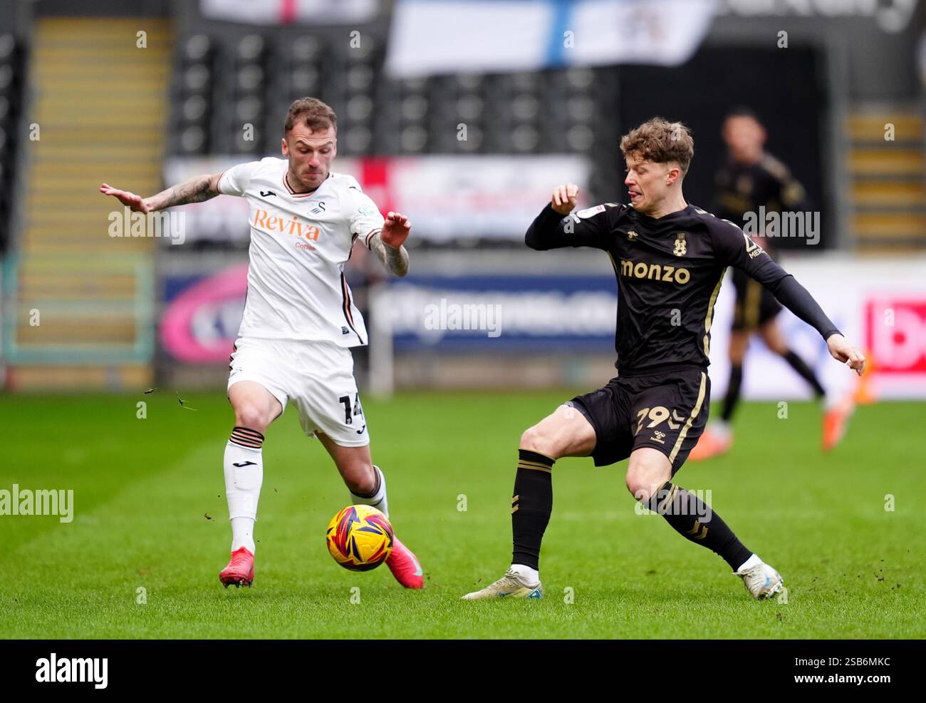 Swansea City's Josh Tymon (left) and Coventry City's Victor Torp battle ...