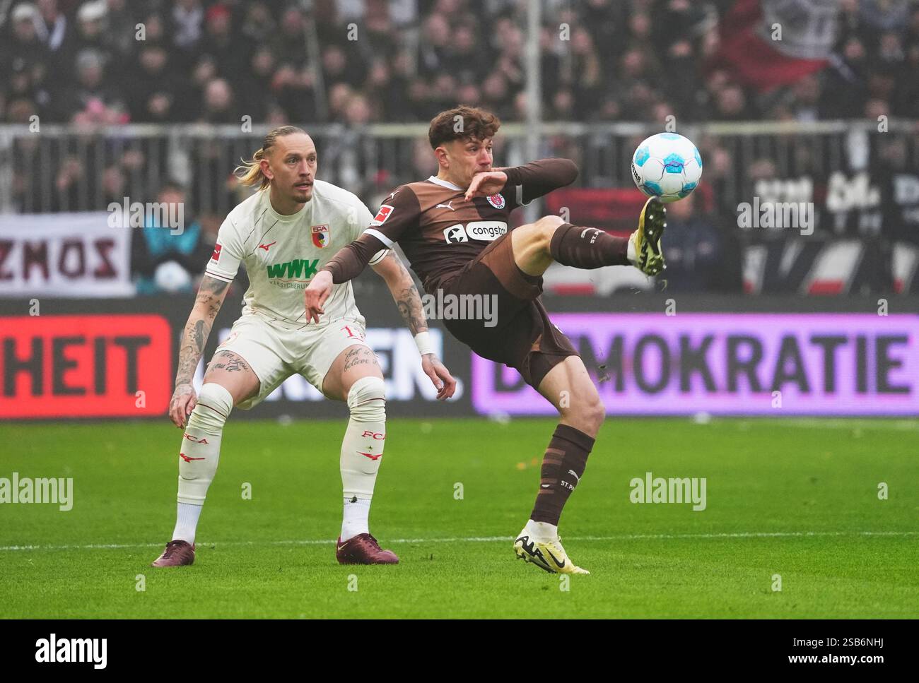 St. Pauli's Philipp Treu, right, and Augsburg's Marius Wolf fight for ...