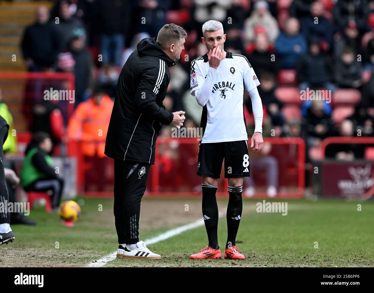 Salford City's Matthew Lund (right) speaks with Salford City's head ...
