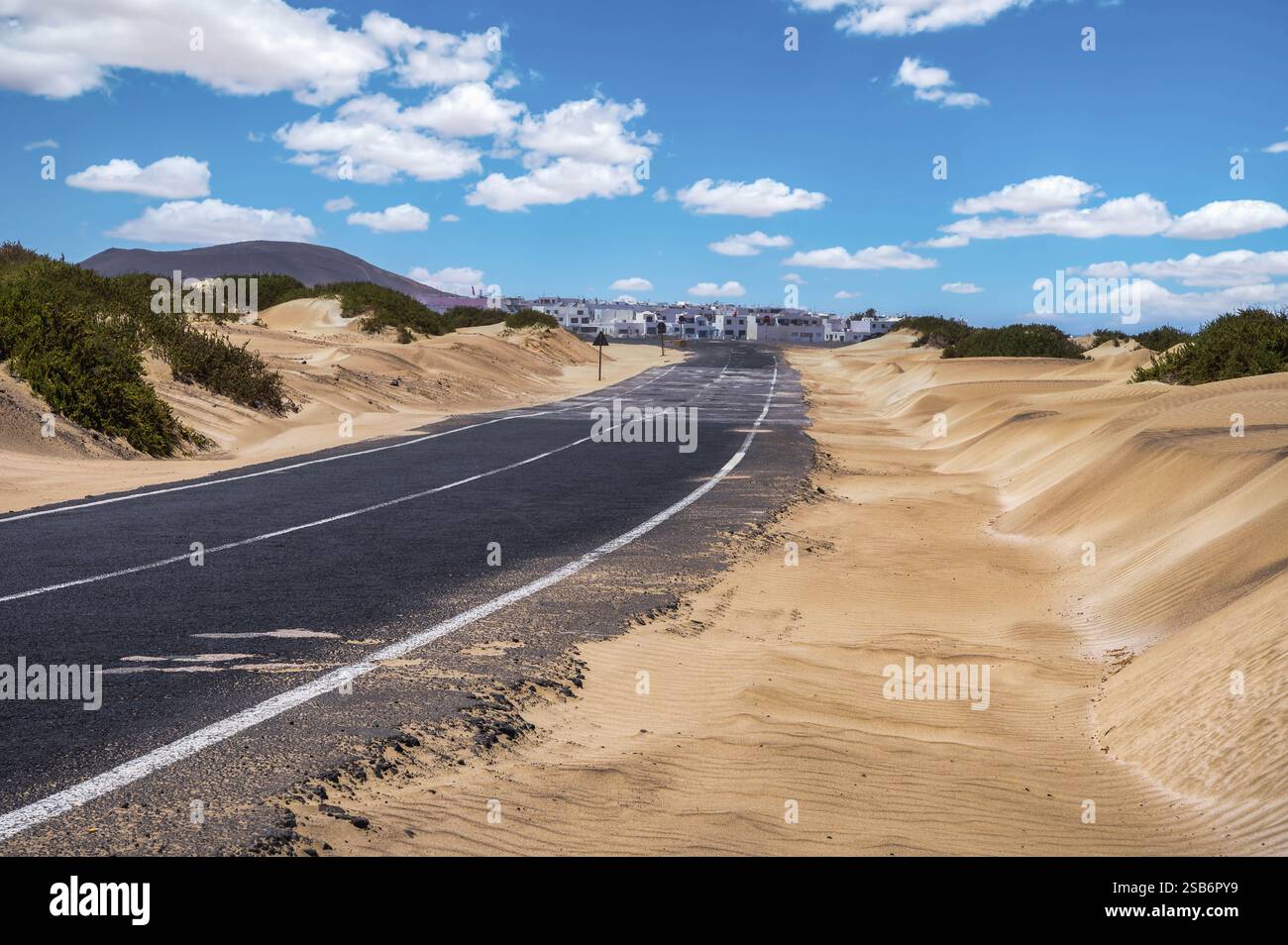 Country road with sand dunes to Caleta Famara, Teguise. Lanzarote ...