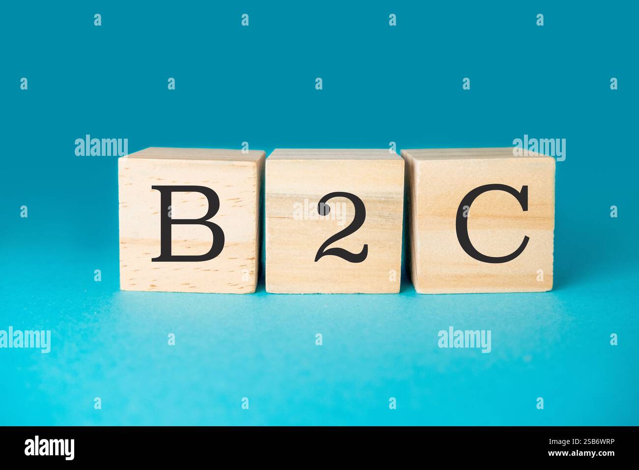 Three wooden blocks spell out the word B2C. The blocks are arranged in ...