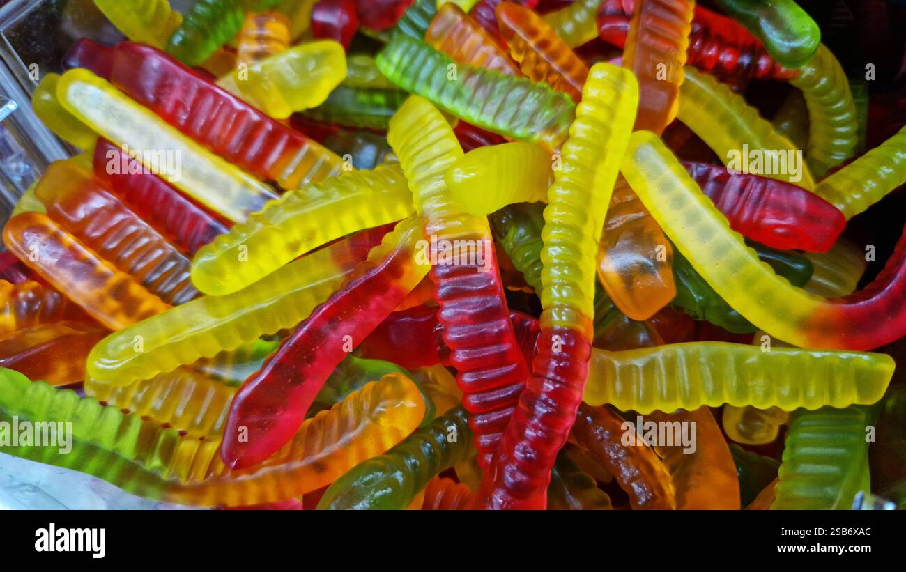 Colorful gummy worms. Close-up of gummy candies. Candy section in a ...