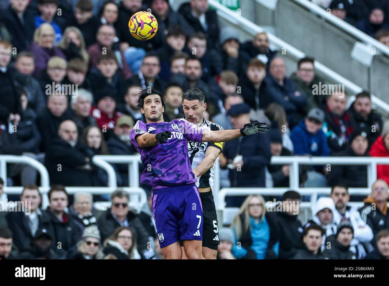 Raul Jimenez of Fulham jumps for the ball with Fabian Schar of ...