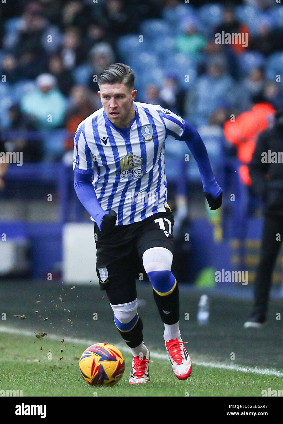 Charlie McNeill of Sheffield Wednesday dribbles the ball forward during ...