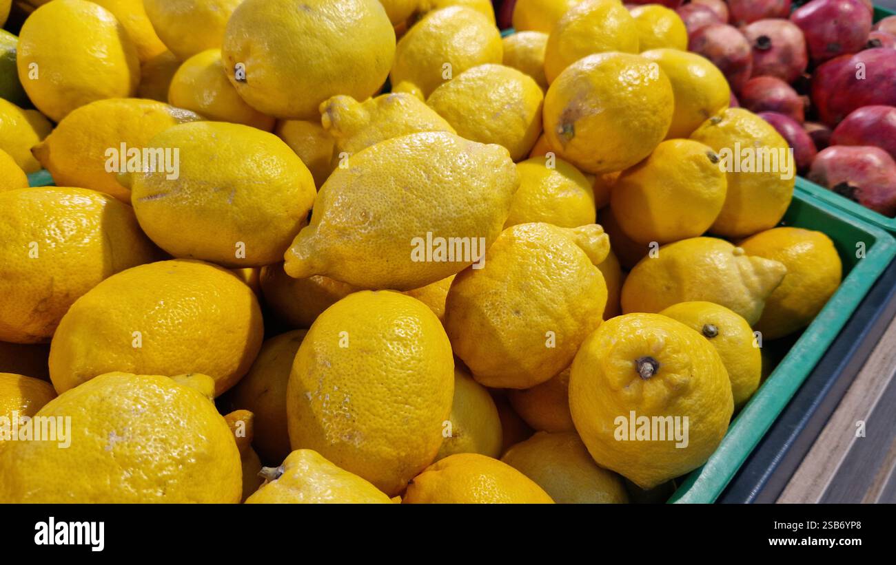 Sale of lemons in a supermarket. Citrus fruits in plastic boxes, close ...