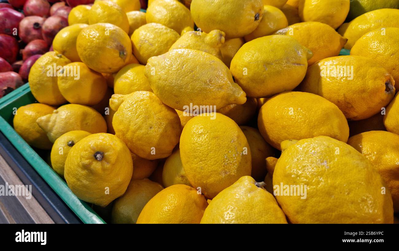 Sale of lemons in a supermarket. Citrus fruits in plastic boxes, close ...
