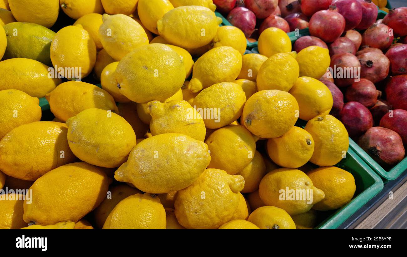 Sale of lemons in a supermarket. Citrus fruits in plastic boxes, close ...
