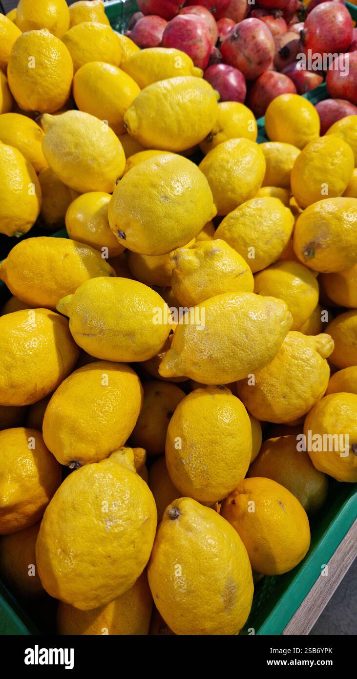 Sale of lemons in a supermarket. Citrus fruits in plastic boxes, close ...