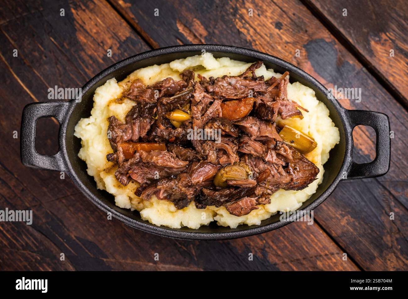 Braised Beef Cheek, Slow cooked meat with smashed potatoes in a skillet ...