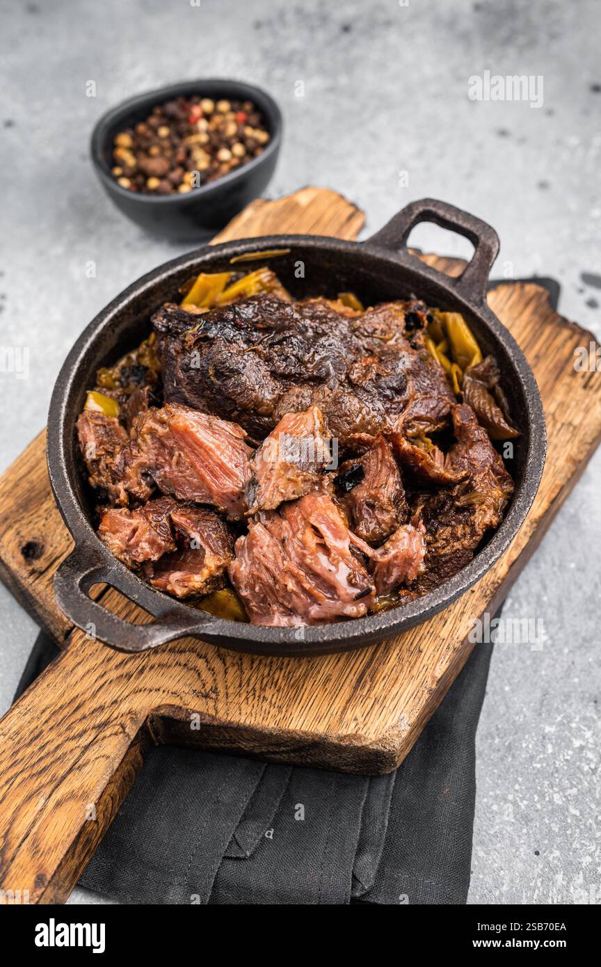 Red Wine Braised Beef Cheek meat with Creamy sauce in a skillet. grey ...