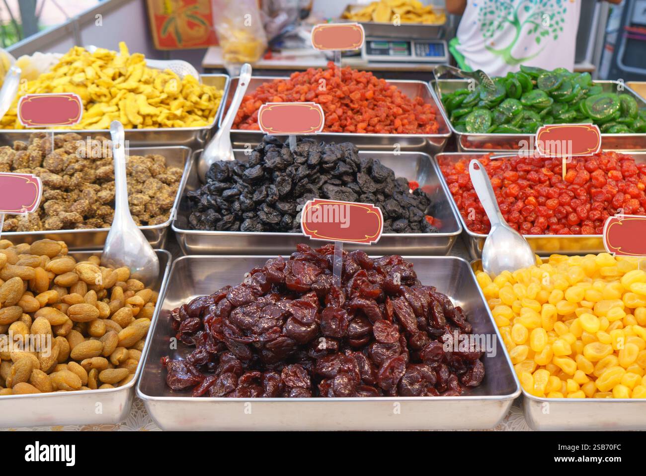 vibrant assortment of Thai candied fruits displayed in stainless steel ...