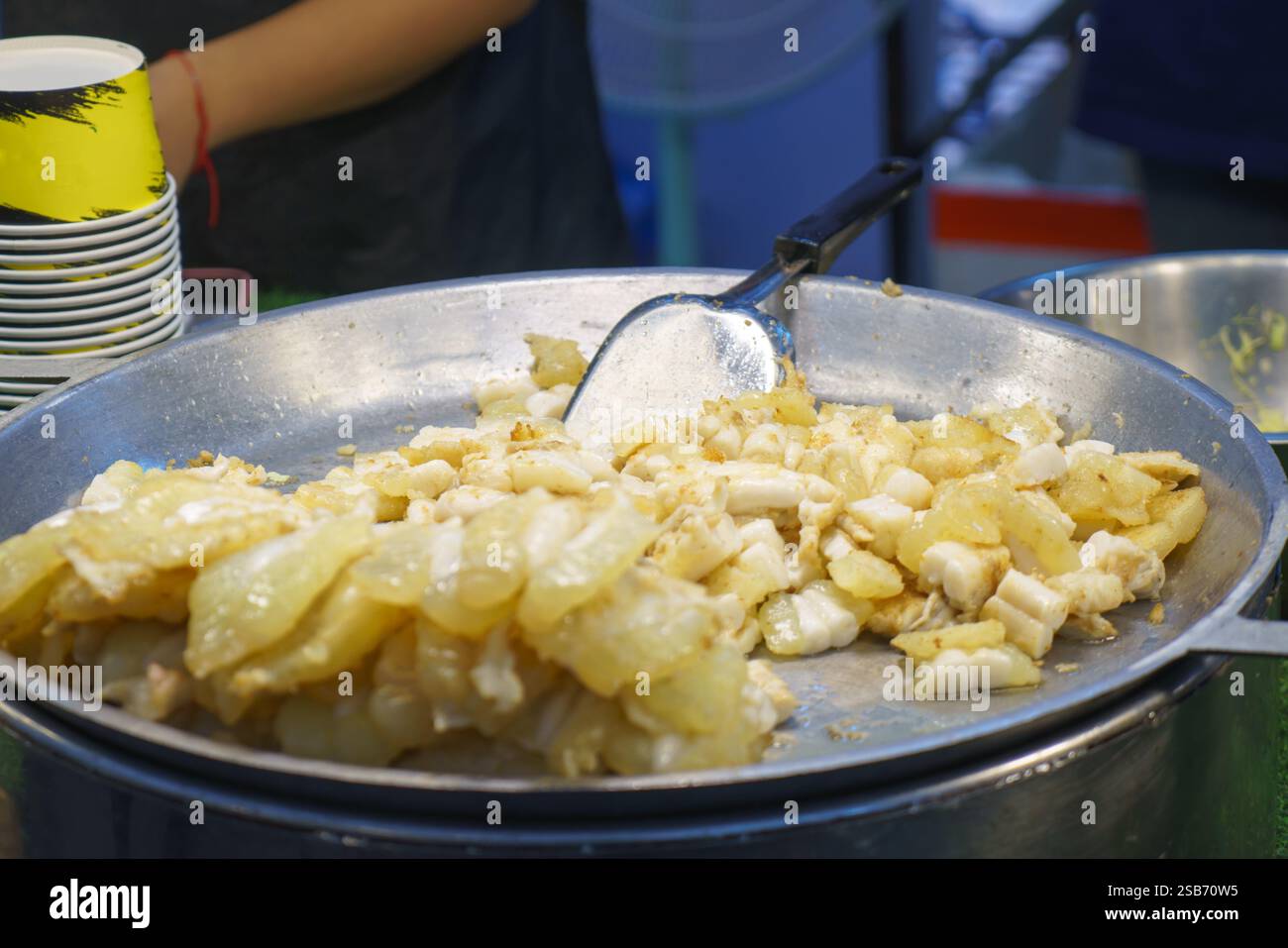 close-up shot of stir-fried squid eggs cooked in a large wok at a ...