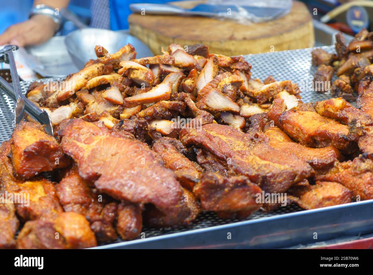 close-up of freshly cooked crispy deep-fried pork slices displayed at a ...
