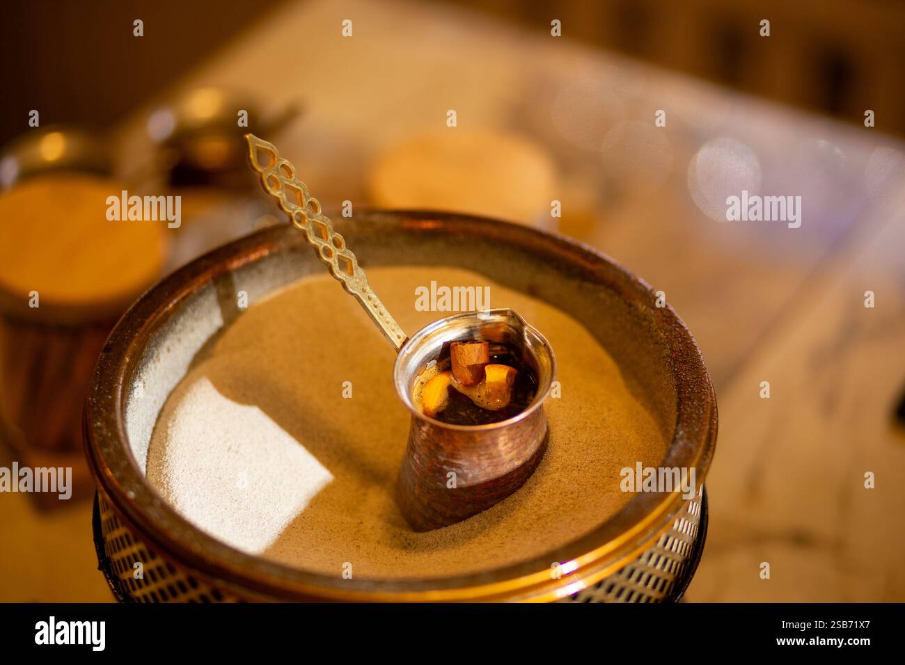 Turkish Sand Coffee making. Preparation of Turkish coffee in the cezve ...