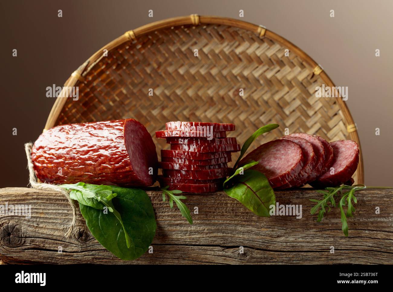 Sliced salami with greens on a old wooden board Stock Photo - Alamy