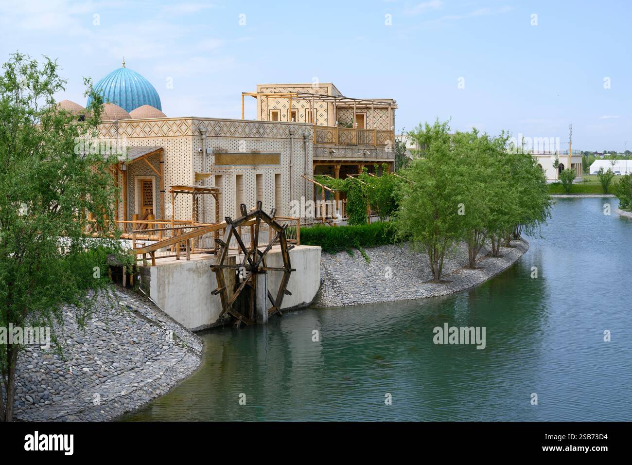 Canal and buildings of national architecture in the Silk Road Tourist ...
