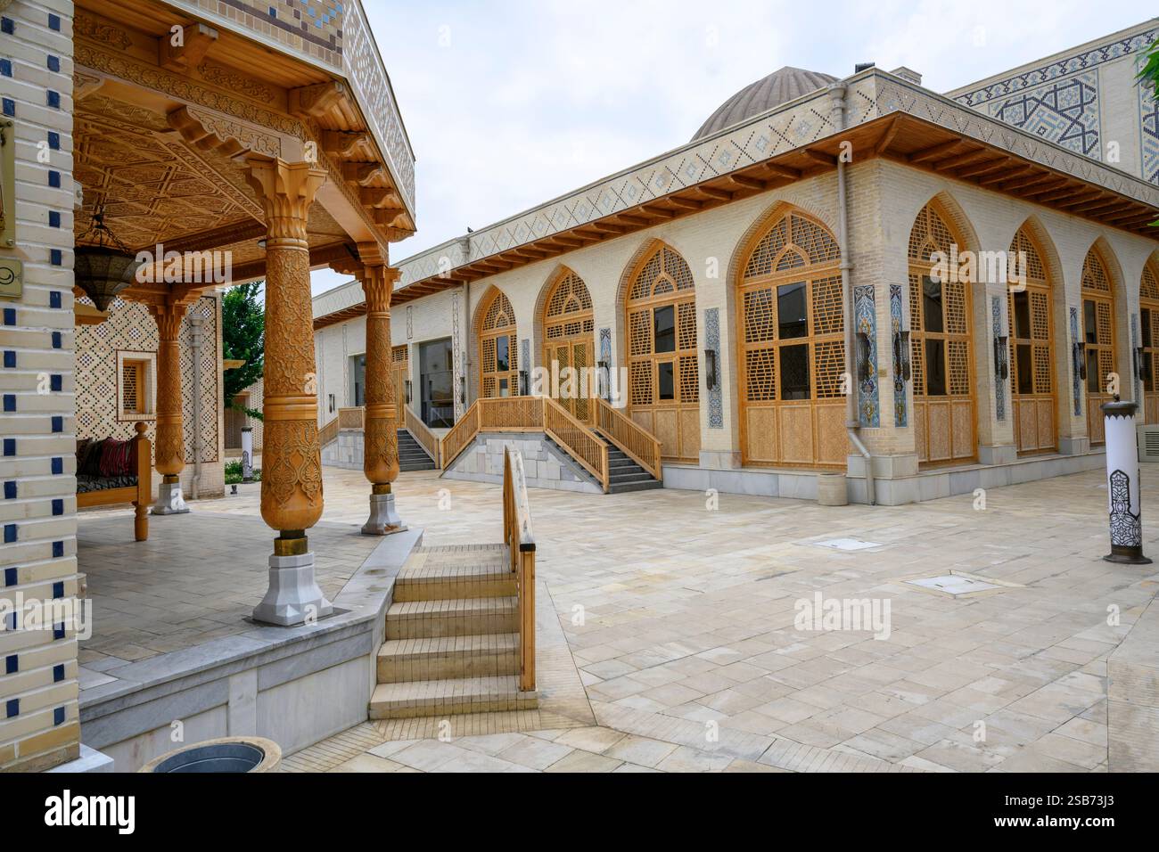 Fragments of buildings with wooden carvings and traditional Uzbek ...